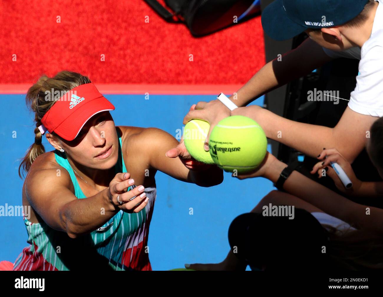 Angelique Kerber of Germany signs autographs after defeating compatriot ...