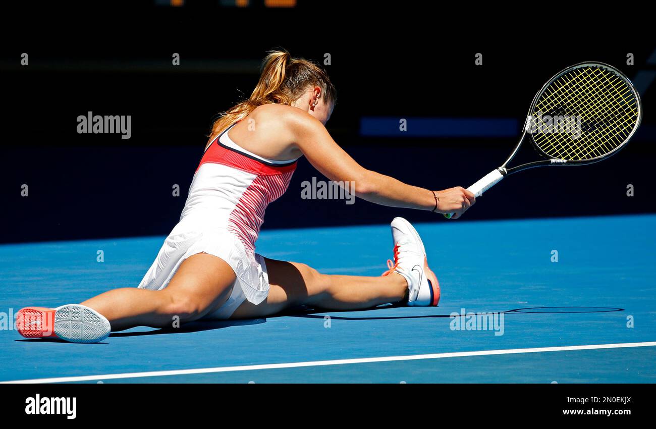 Annika Beck of Germany slips on the court after making a return to ...