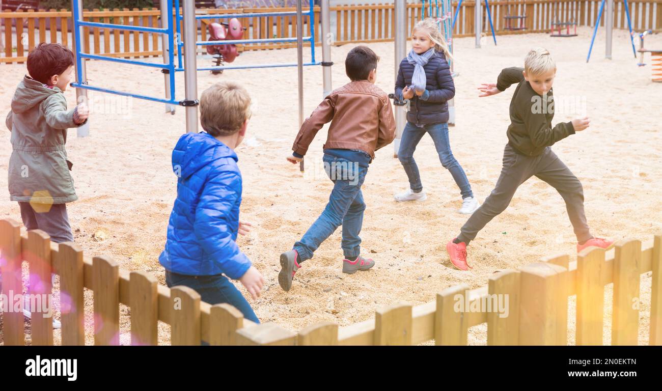 Children playing tag on playground Stock Photo - Alamy