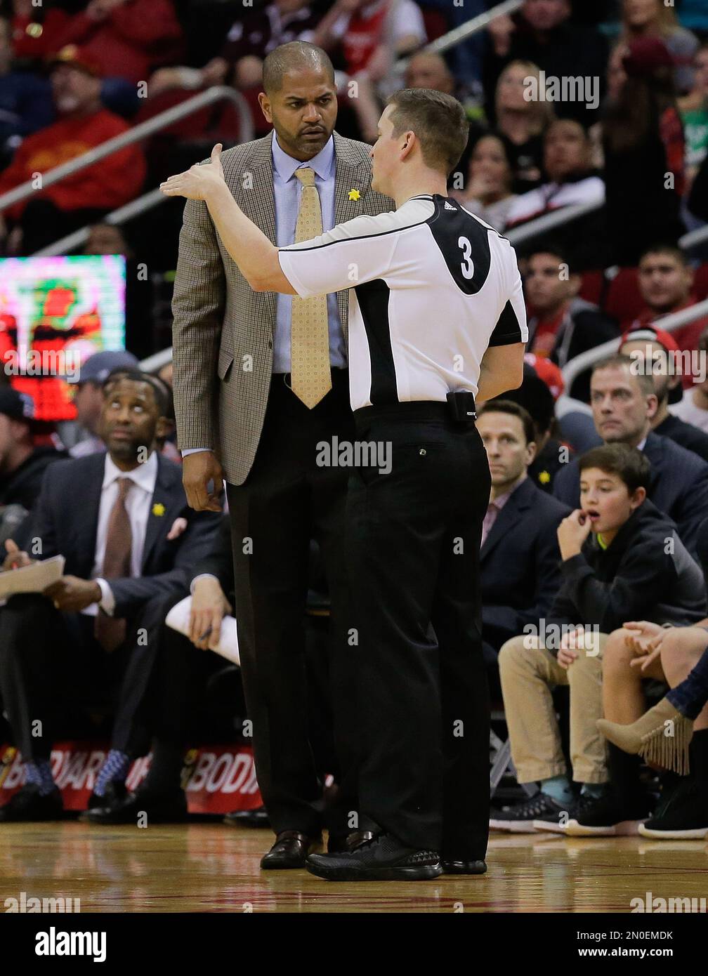 Referee Nick Buchert (3) explains to Houston Rockets interim head coach ...