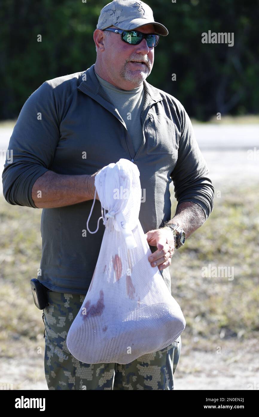 Bill Booth of Bradenton, Fla., prepares to turn in a dead python at a ...