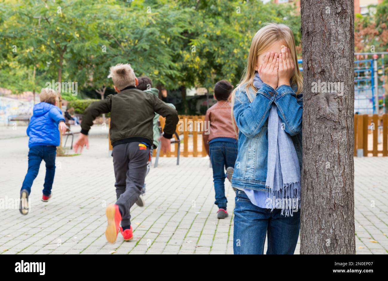 Kids playing hide and seek on the street Stock Photo - Alamy