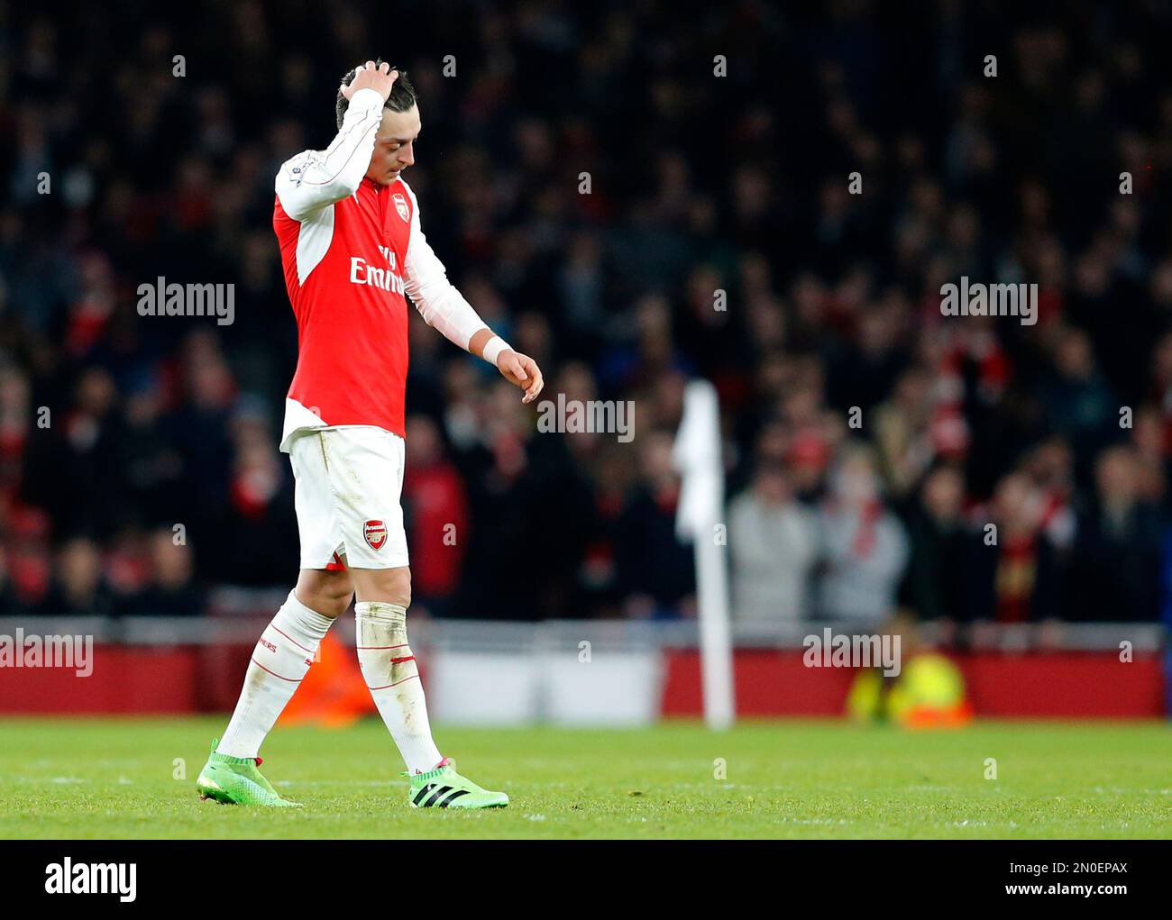 Arsenal's Mesut Ozil puts his hand to his head as he waits for a free ...