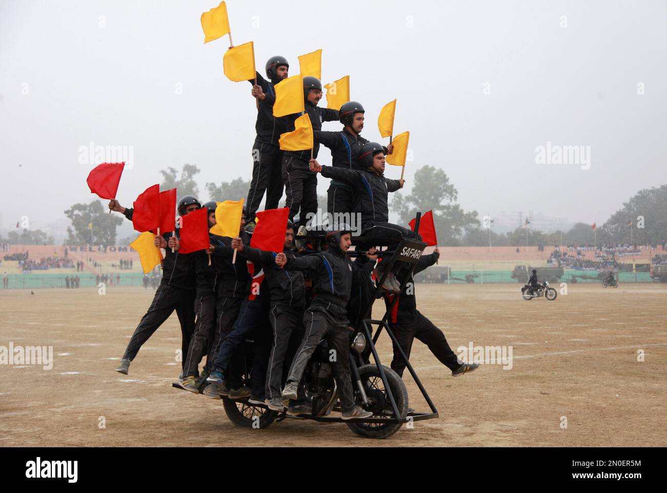 Indian policemen perform acrobatics on a motorcycle during a rehearsal ...