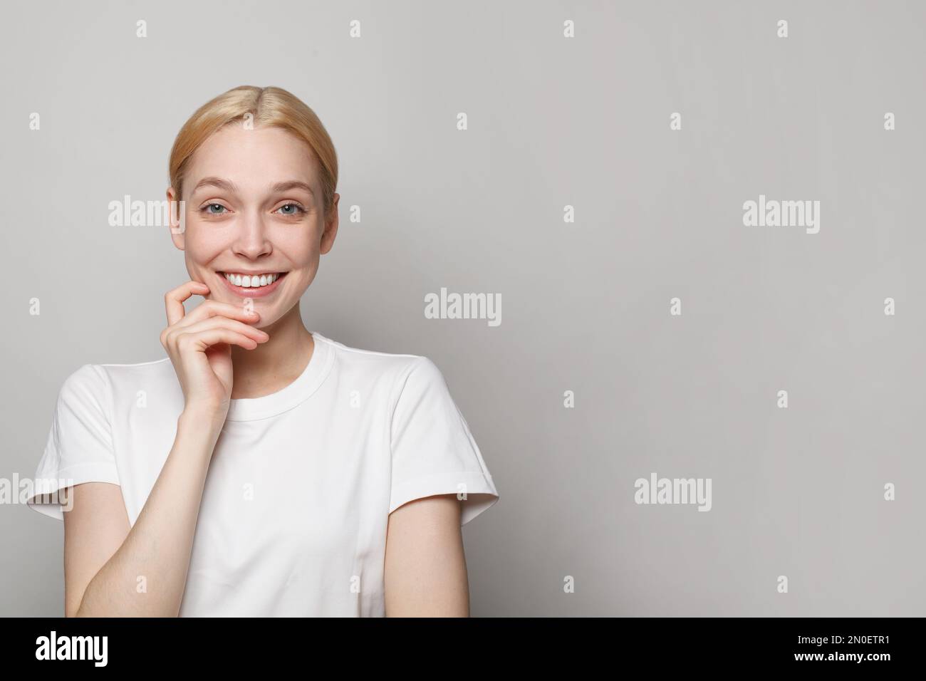 Happy laughing surprised model woman portrait on grey background Stock ...