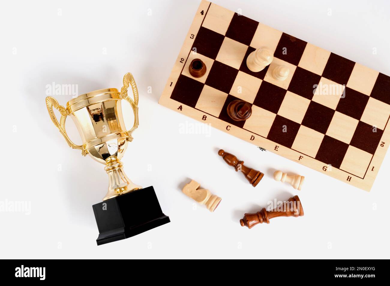 Winner golden cup and Chess board with wooden figures still life on ...