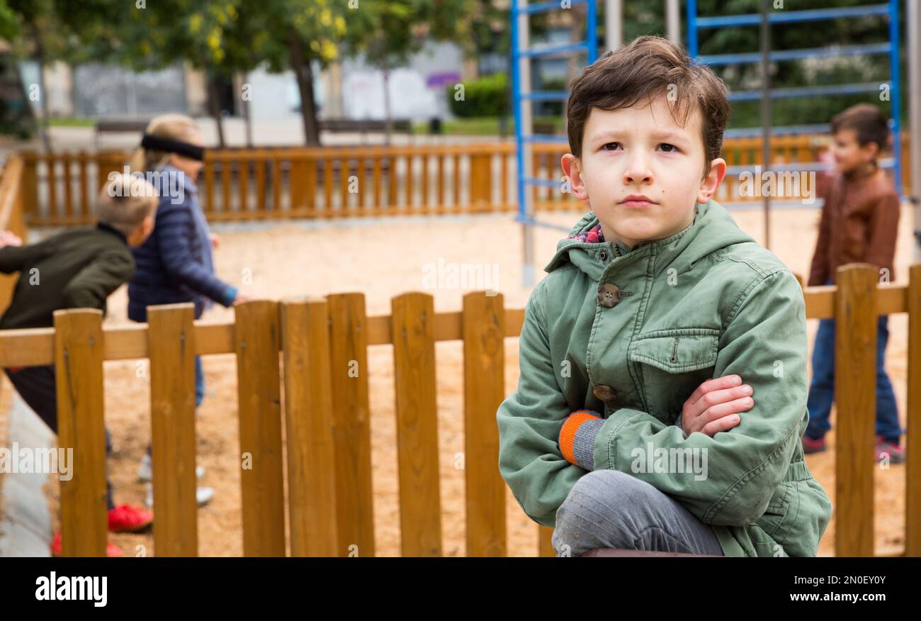 Offended boy on playground Stock Photo - Alamy