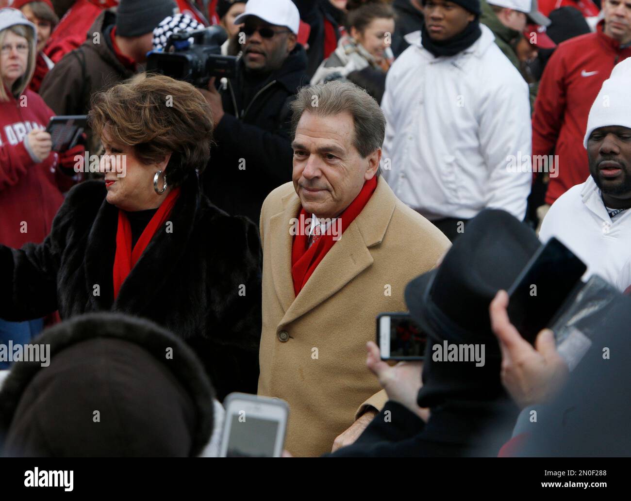 Alabama head coach Nick Saban and wife Terry walk through a sea of fans ...