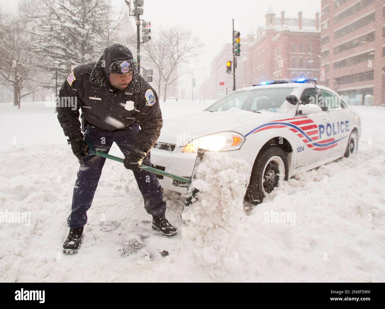 Washington Metropolitan Police Officer W.J. Peterson, shovels snow to ...