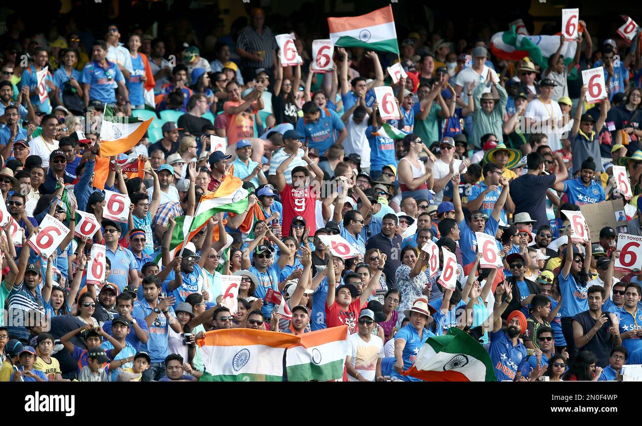 Indian cricket fans wave flags and hold up signs' that say 6 in support ...
