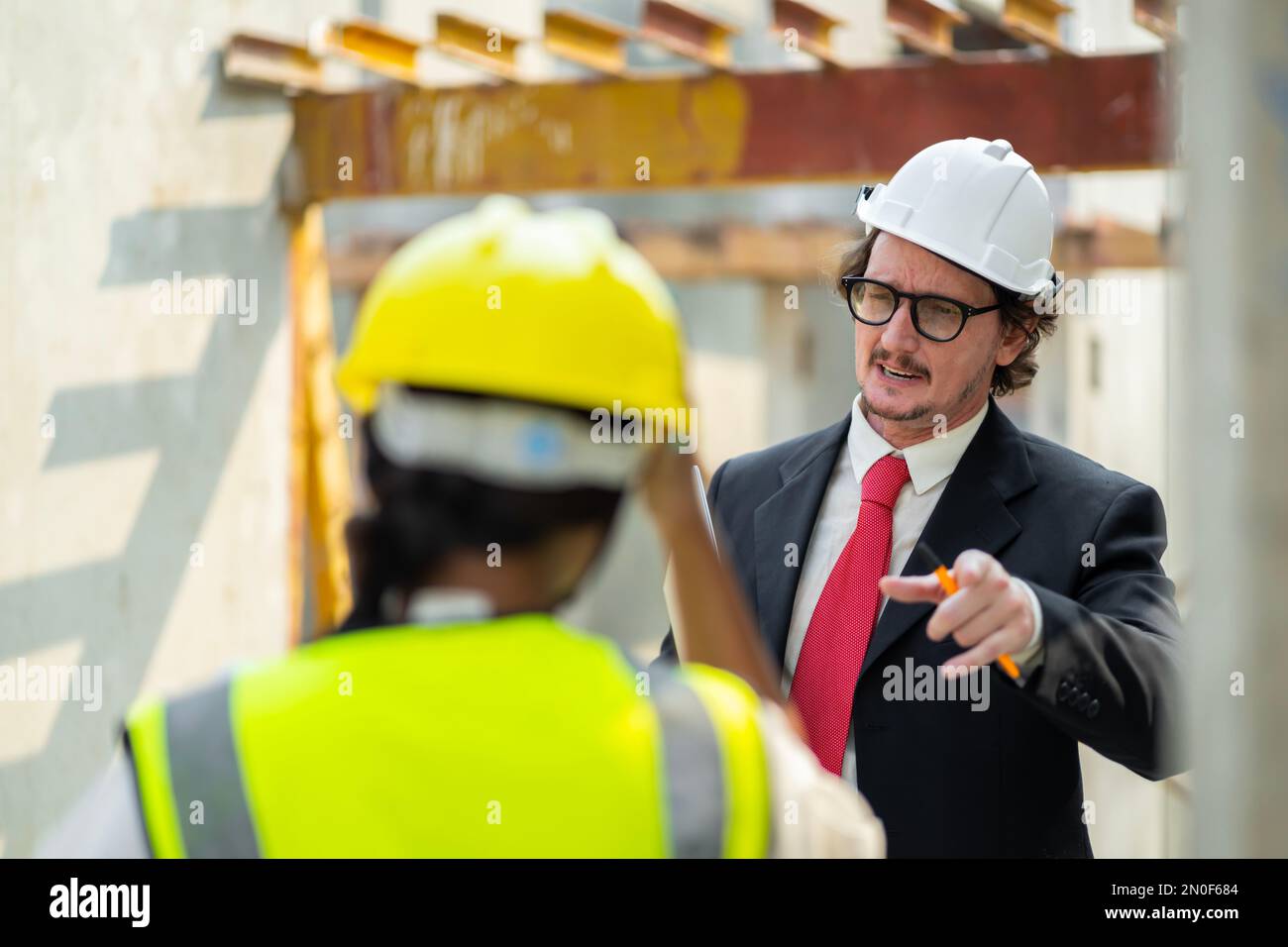 Male engineers are inspecting and controlling the work of the employees ...
