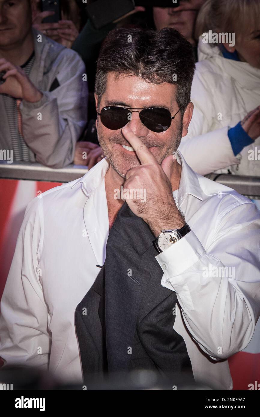 Simon Cowell poses for photographers upon arrival at a photo call for ...