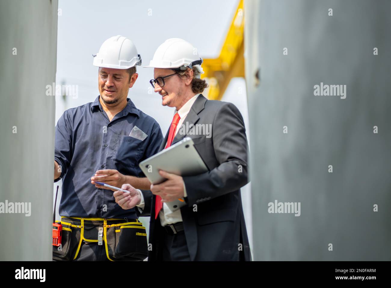 Male engineers are inspecting and controlling the work of the employees ...