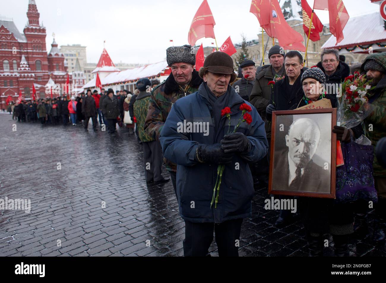 Pro-Communist Muscovites hold Soviet flags and a portrait of the Soviet ...