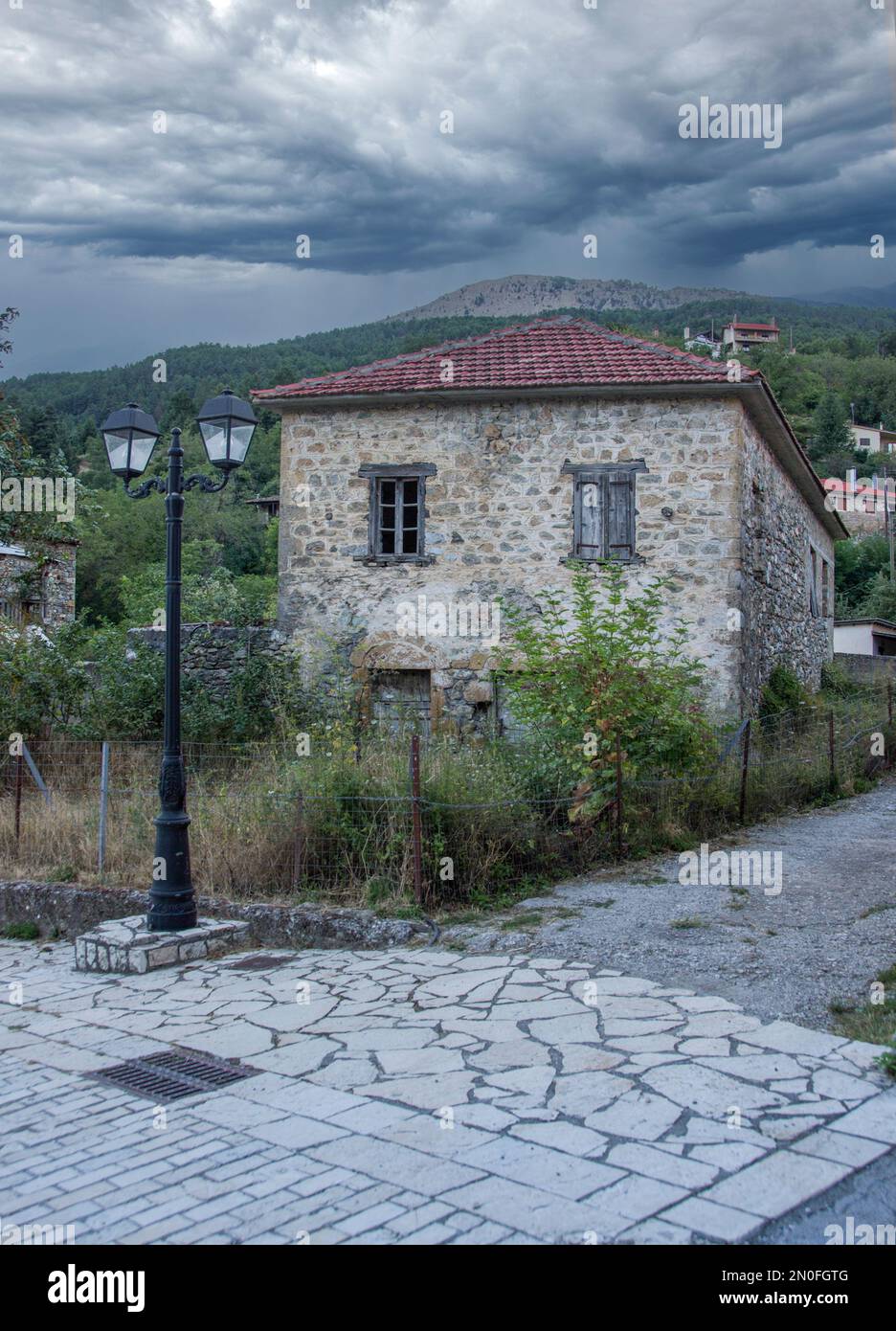 Street and houses in Zarouhla village in Greece. Aroania mountain ...