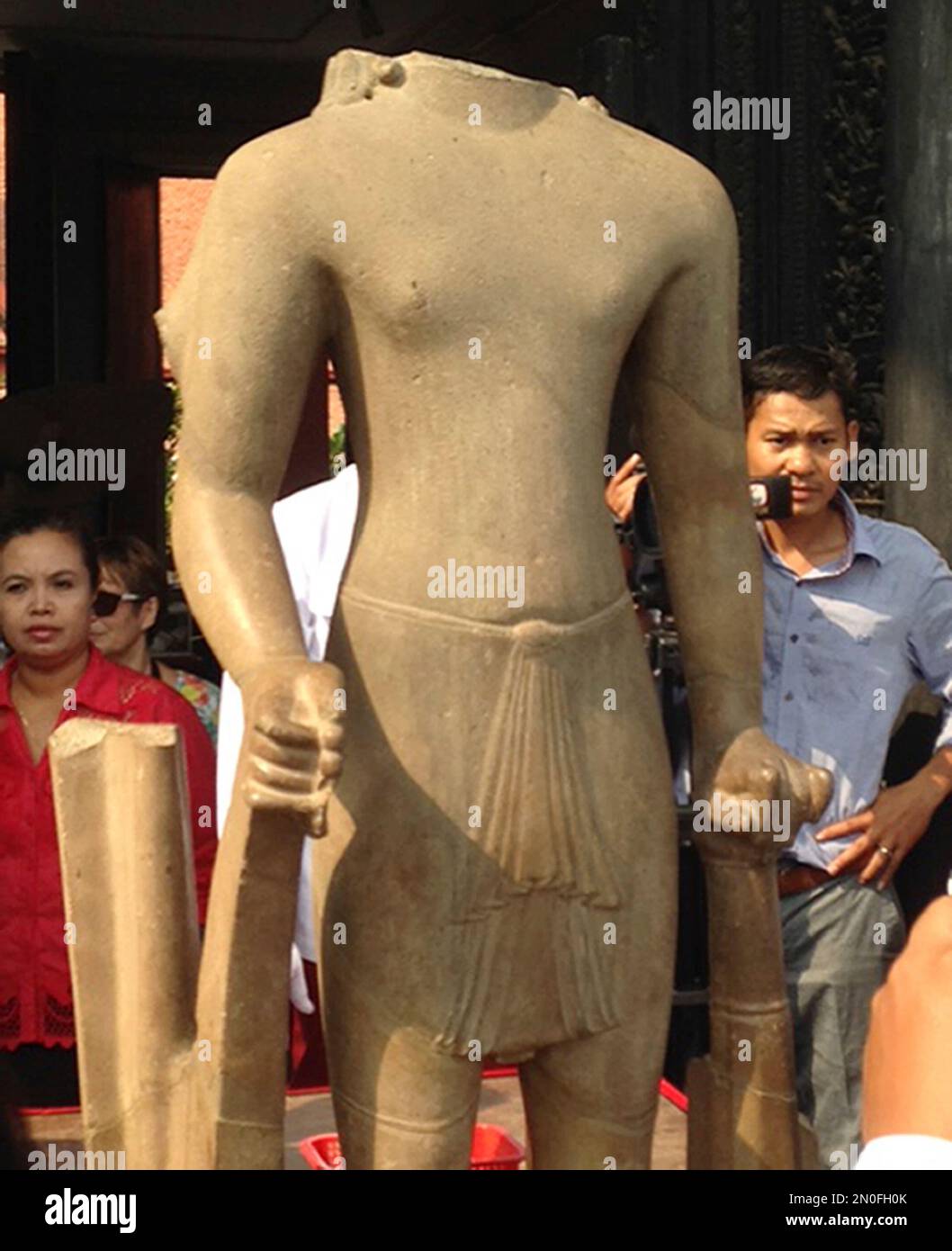 A headless stone sculpture of Harihara, a Hindu deity, is displayed ...