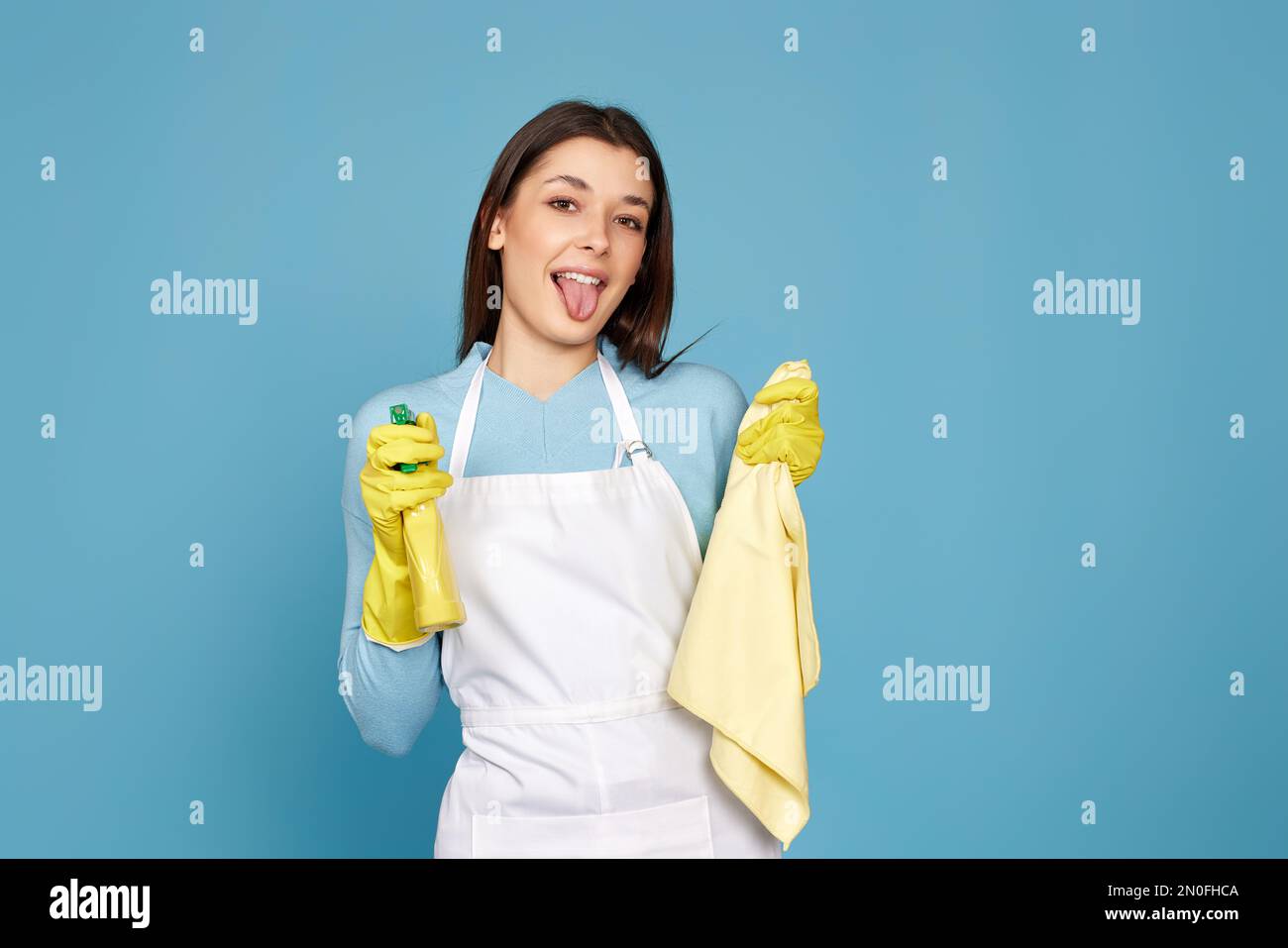 woman in cleaner apron wieaning rag and detergent sprayer Stock Photo ...