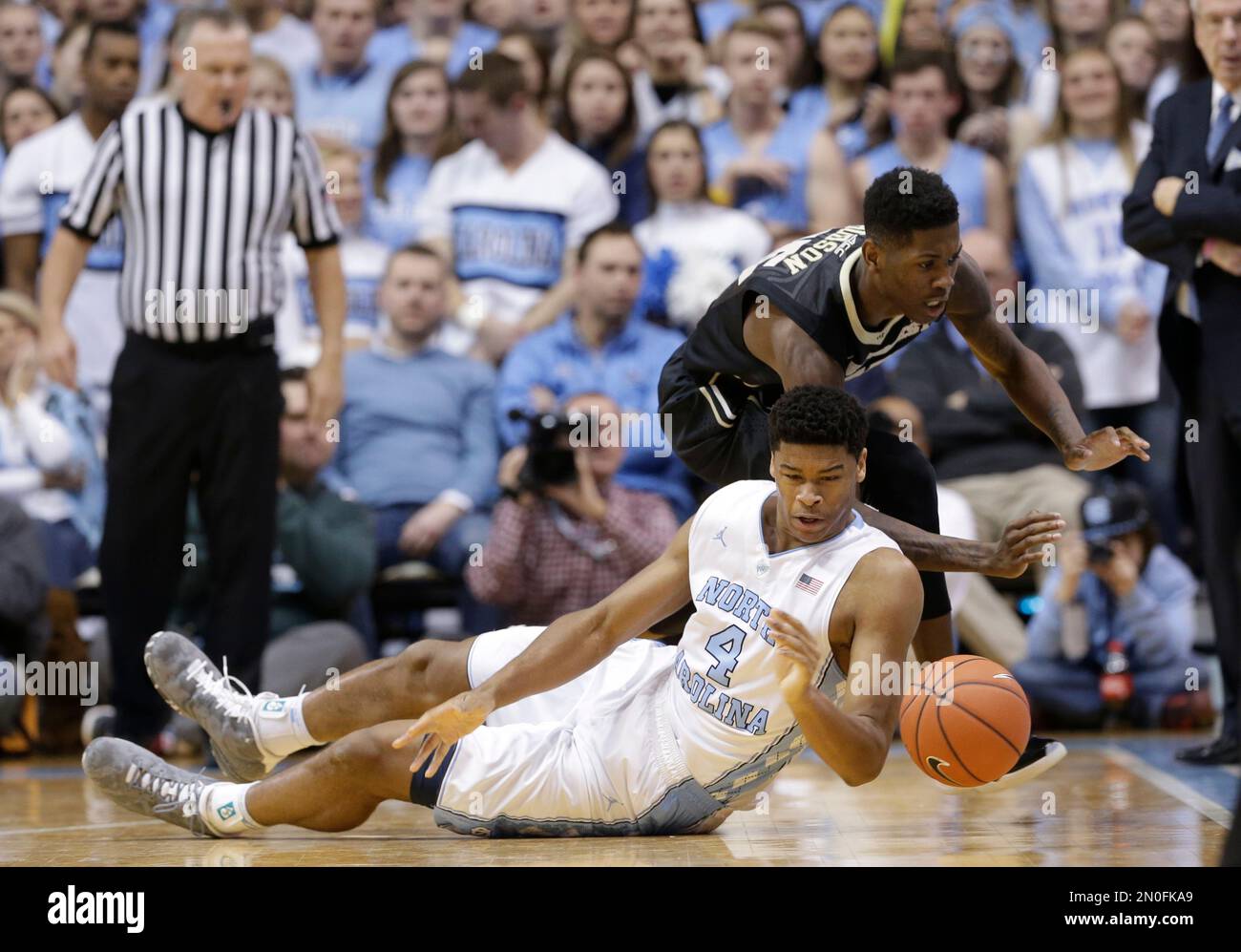 North Carolina's Isaiah Hicks (4) falls as Wake Forests's Cornelius ...