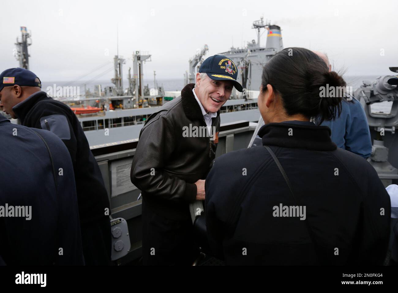 Navy Secretary Ray Mabus, greets a sailor aboard the USS William P ...