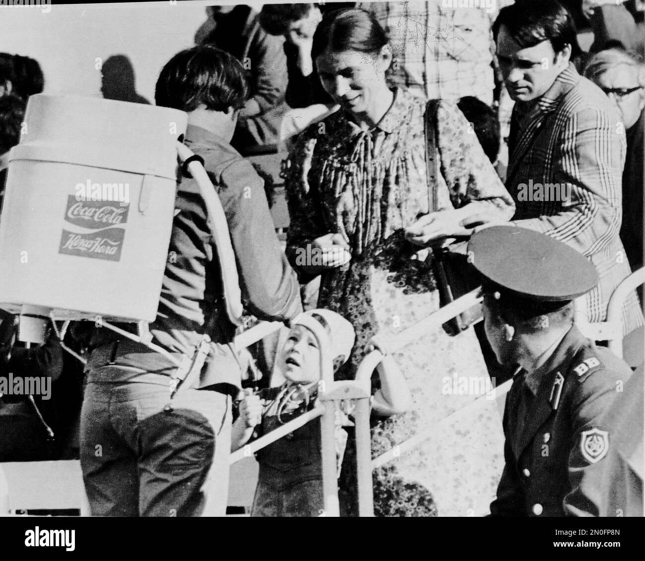 A young Soviet carrying a portable Coca-Cola dispenser on his back ...