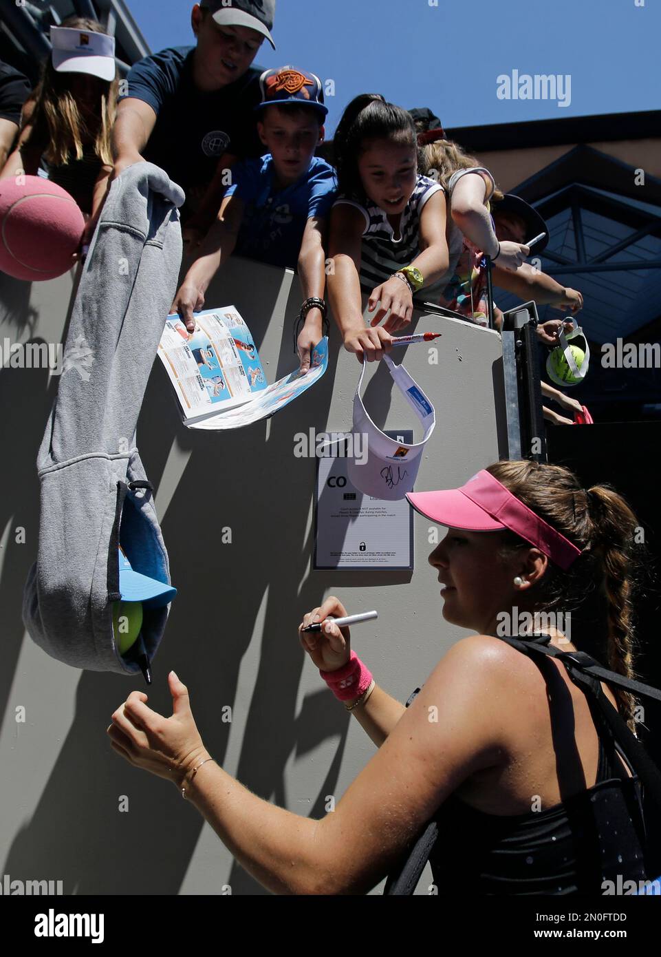 Belinda Bencic of Switzerland signs autographs following her second ...