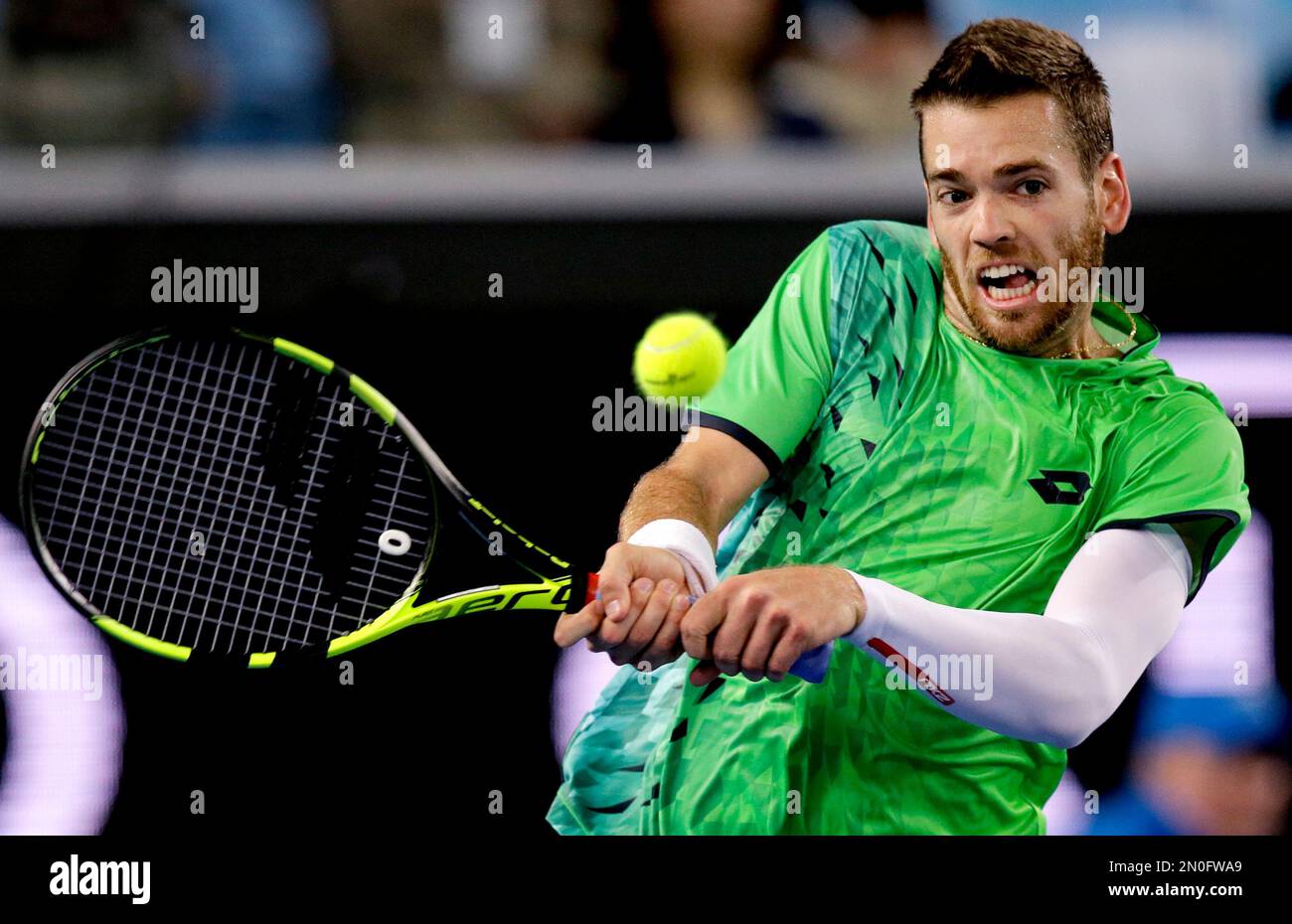 Austin Krajicek of the United States makes a backhand return to Kei ...
