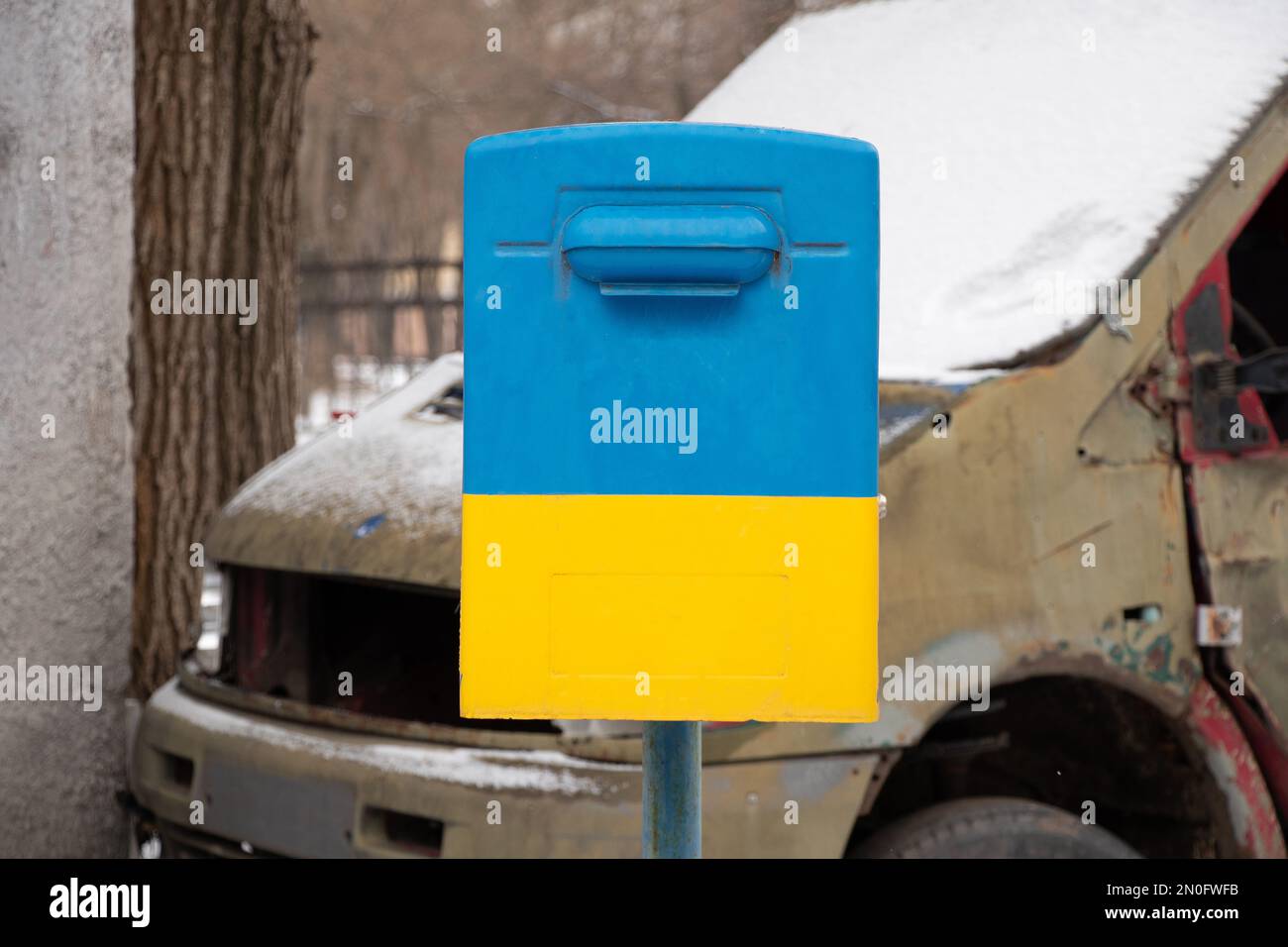 A mailbox in the color of the yellow-blue flag of Ukraine stands in the ...
