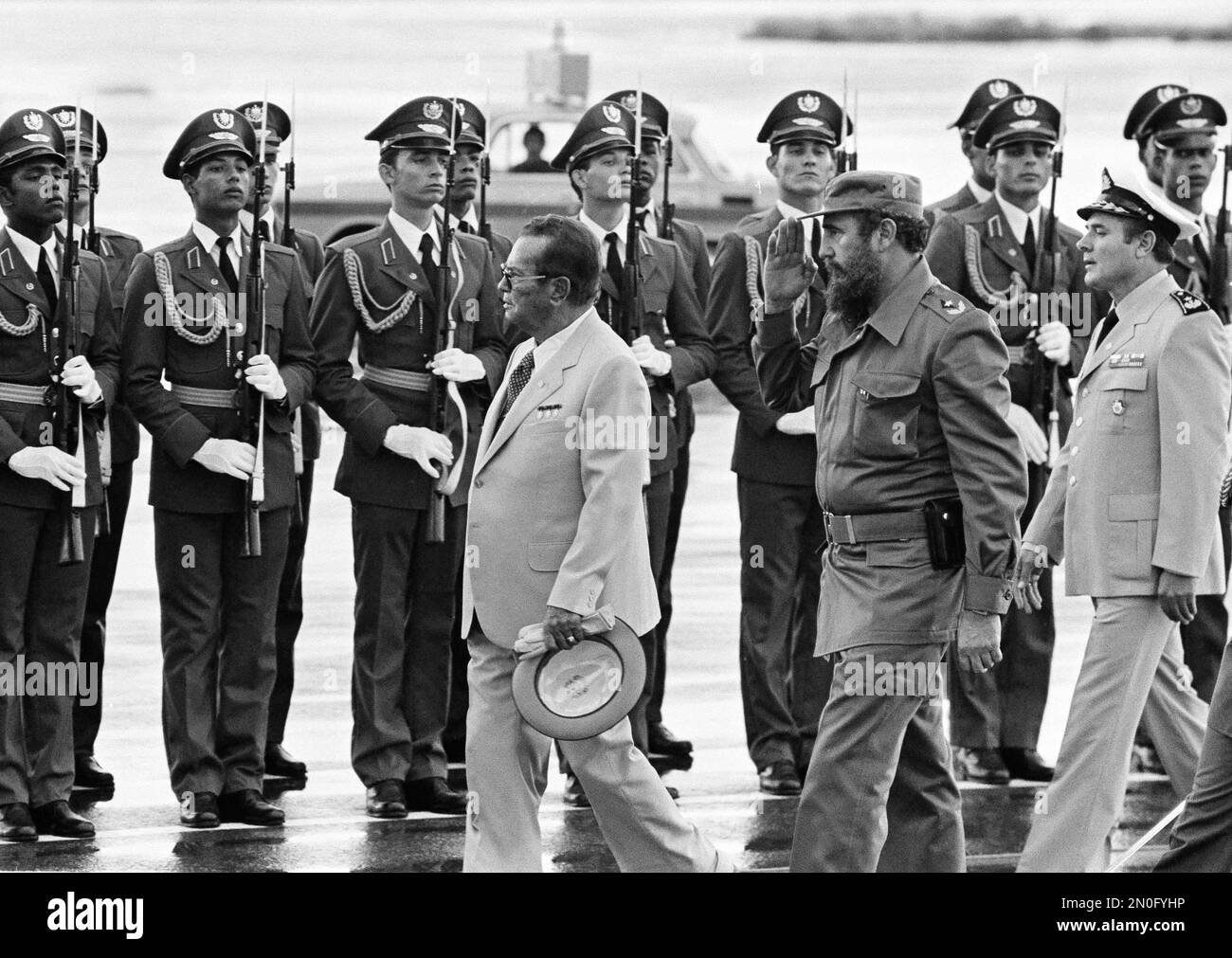 Yugoslav President Josip Broz Tito walks past a Cuban honor guard with ...