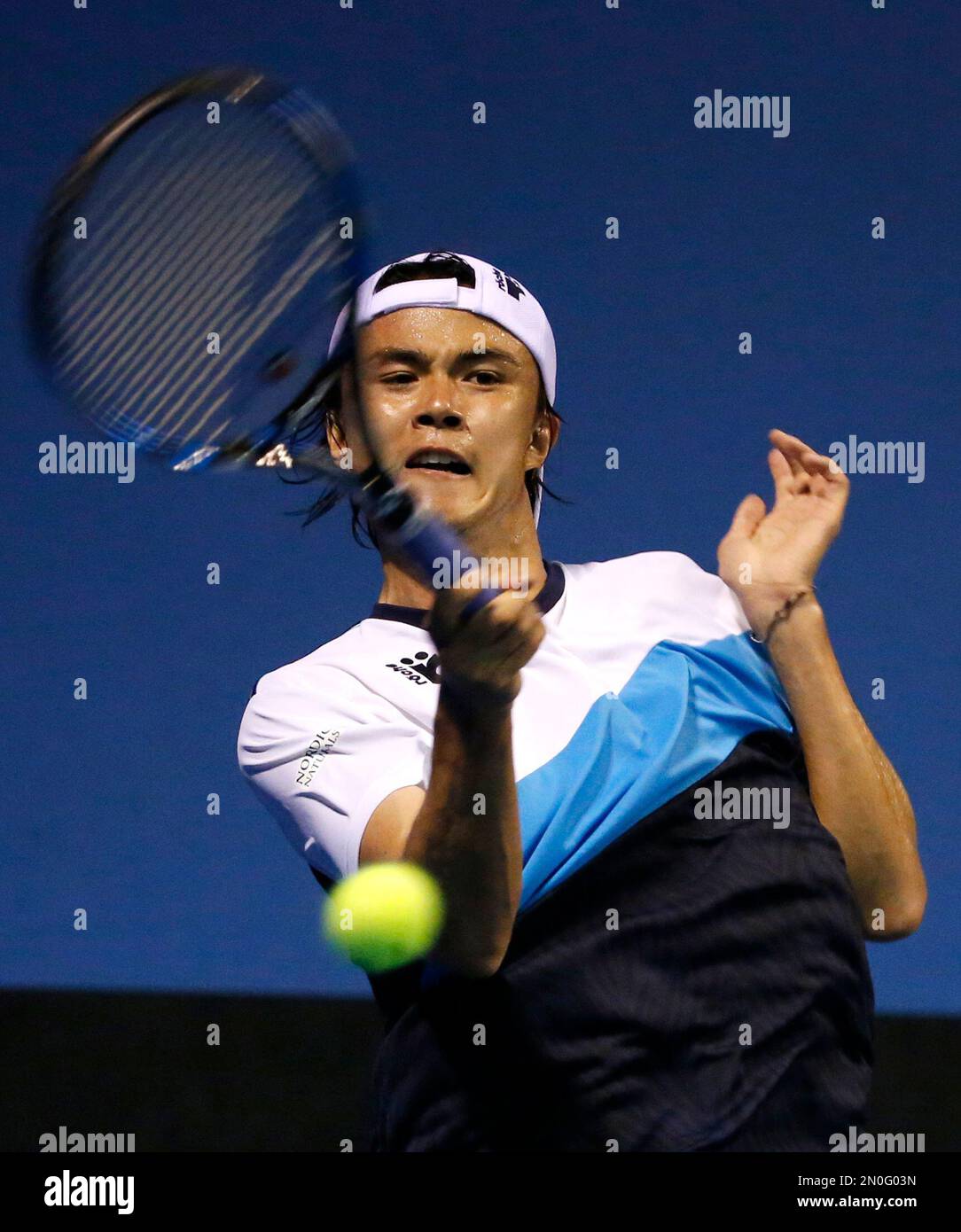 Taro Daniel of Japan makes a forehand return to Lukas Rosol of the ...