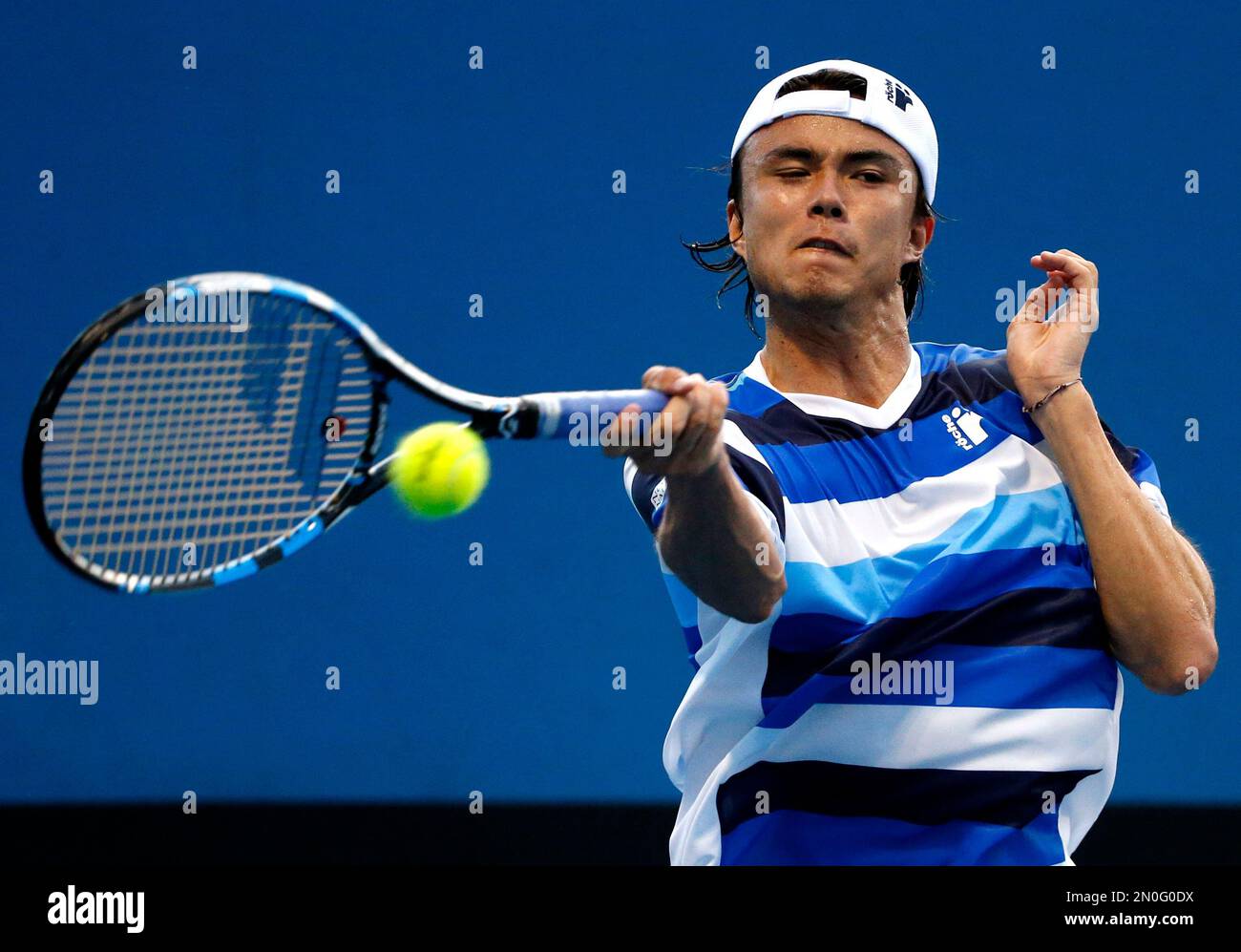 Taro Daniel of Japan makes a forehand return to Lukas Rosol of the ...