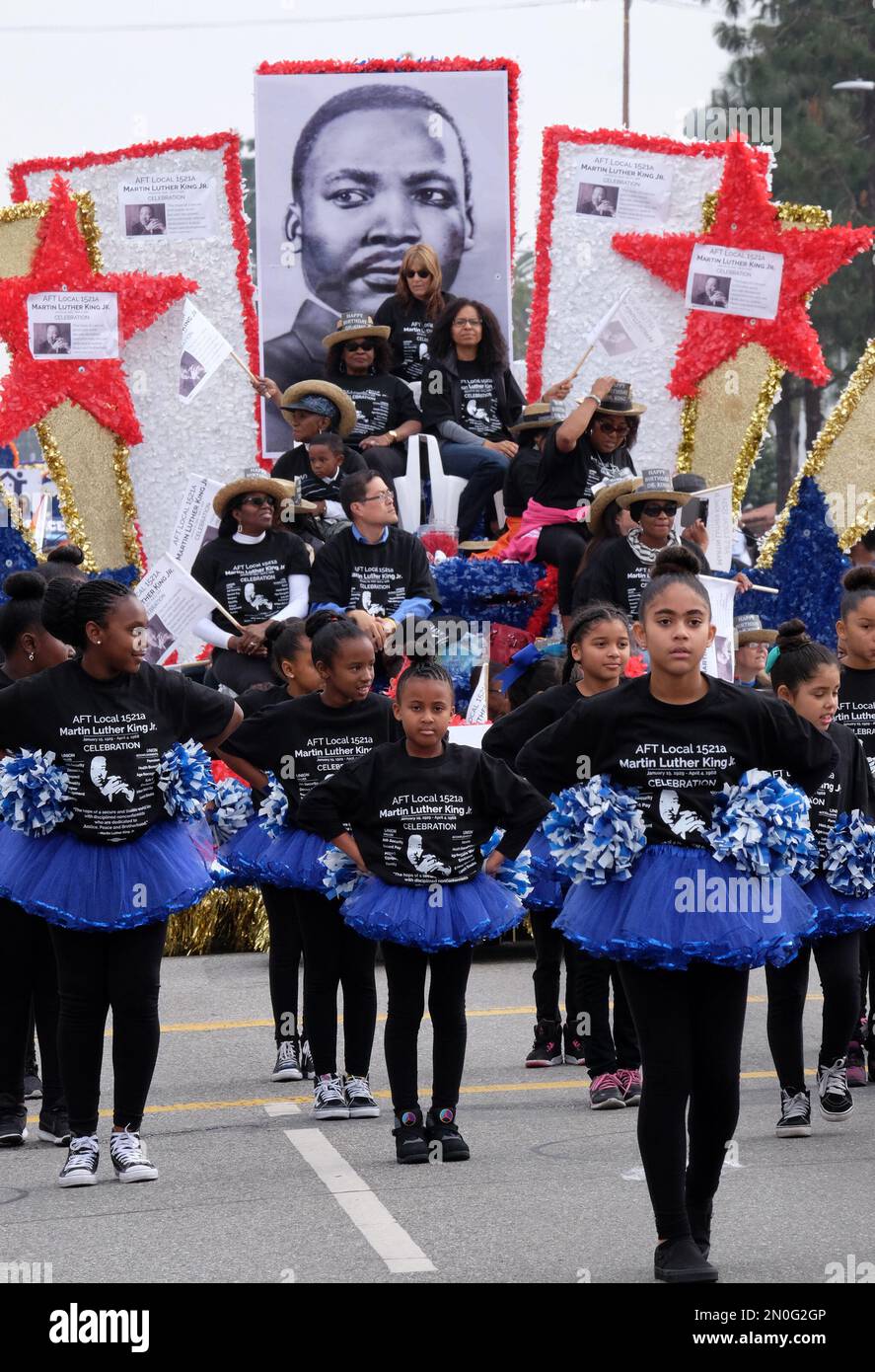A group of dancers parade down Martin Luther King Blvd. during the ...