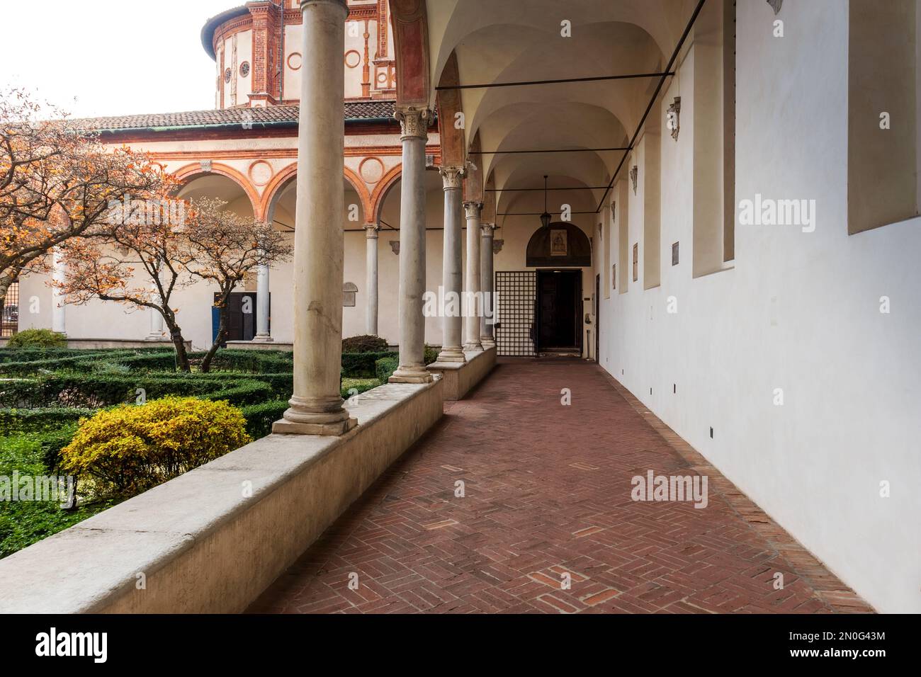 Courtyard of a house with a walking garden and white building columns ...