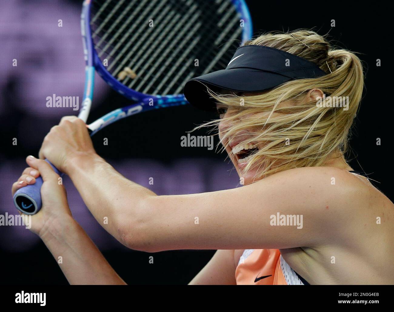 Maria Sharapova of Russia makes a backhand return to Nao Hibino of ...