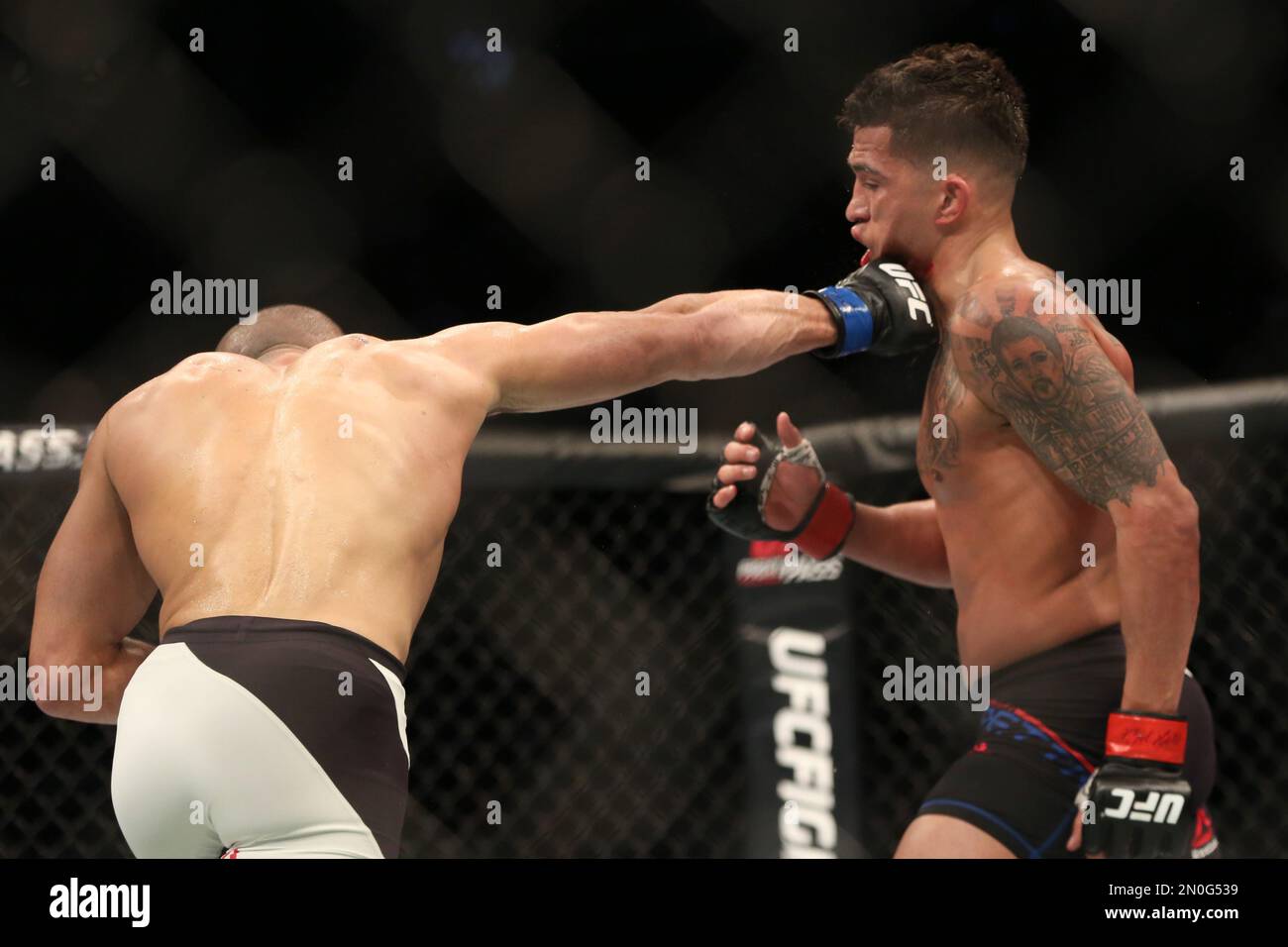 Anthony Pettis takes a punch from Eddie Alvarez in their mixed martial ...