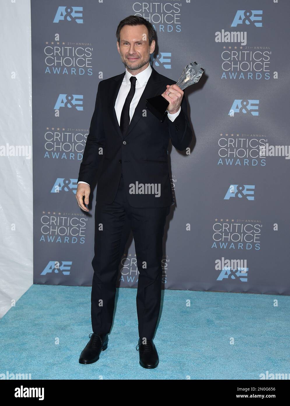 Christian Slater poses in the press room with the award for best ...