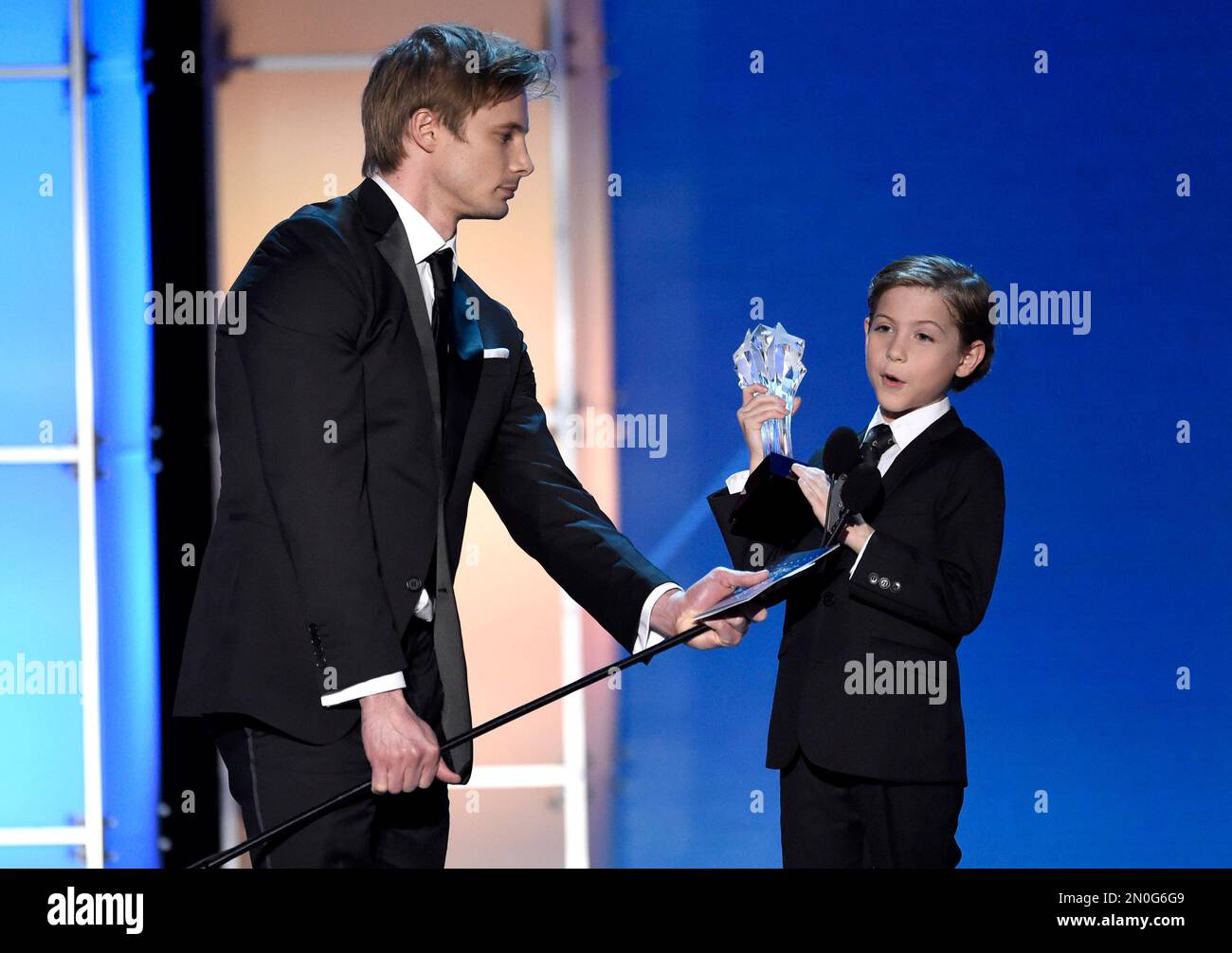 Bradley James, left, holds the microphone for Jacob Tremblay as he ...