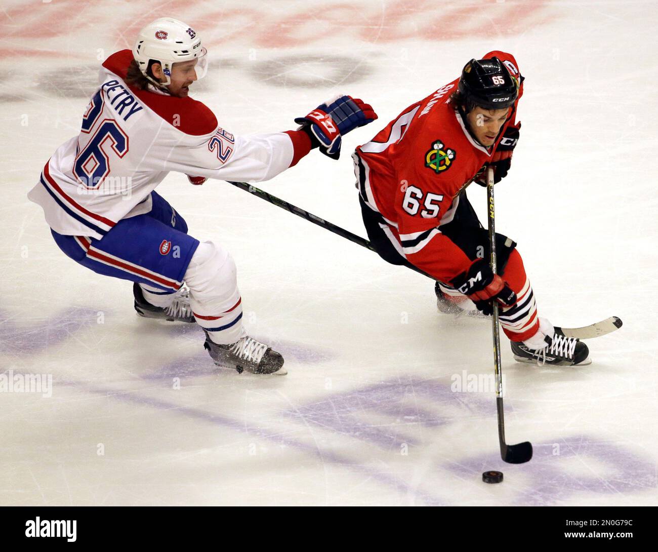 Chicago Blackhawks right wing Andrew Shaw, right, controls the puck ...