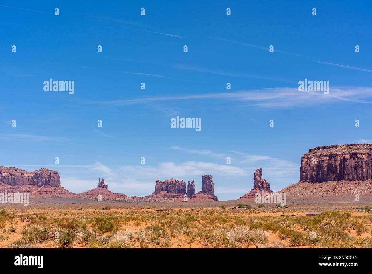 A peaceful desert landscape in a canyon with dry brown fields and rocky ...