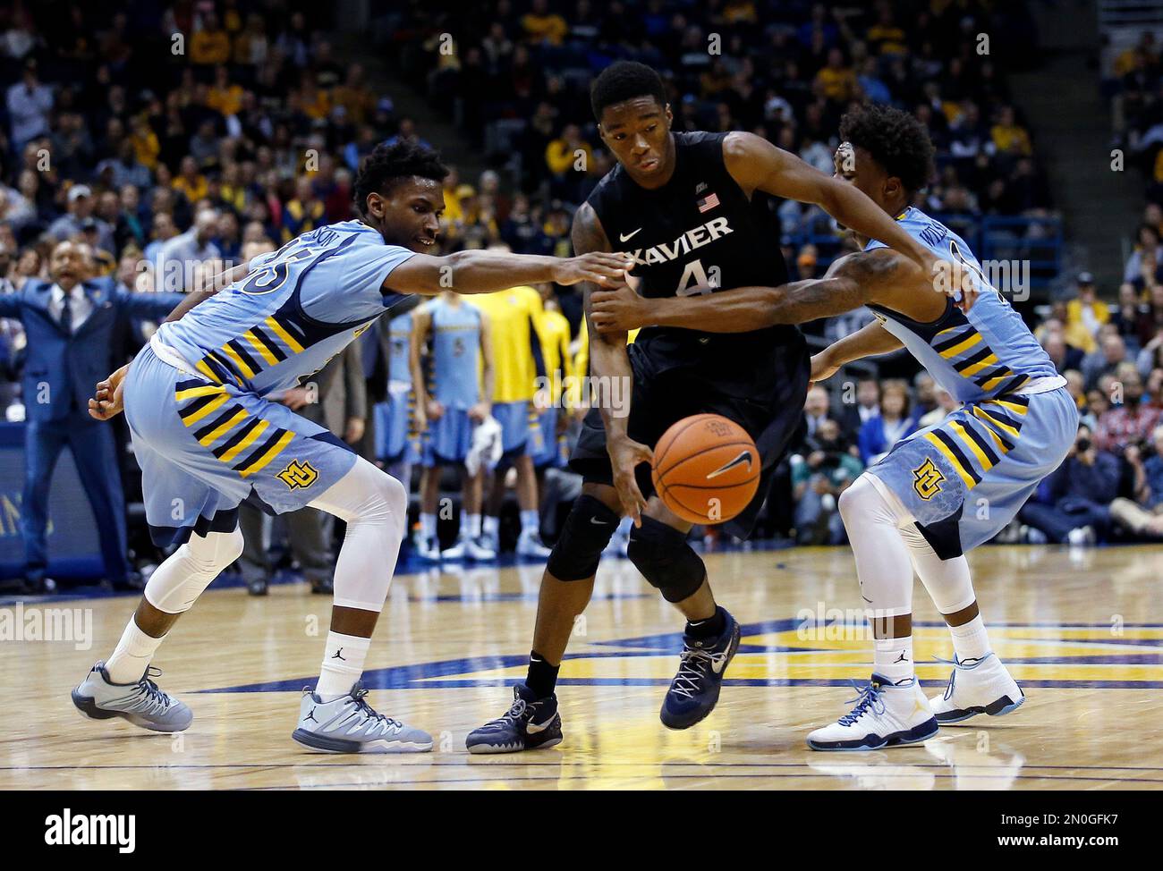 Xavier's Edmond Sumner drives between Marquette's Jajuan Johnson (23 ...