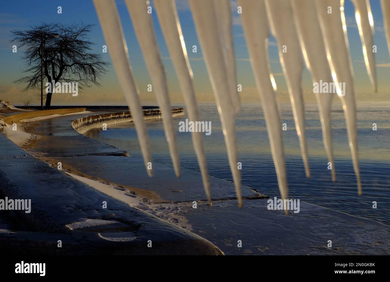 Icicles hang over a rail along the shore of Lake Michigan in Chicago on ...