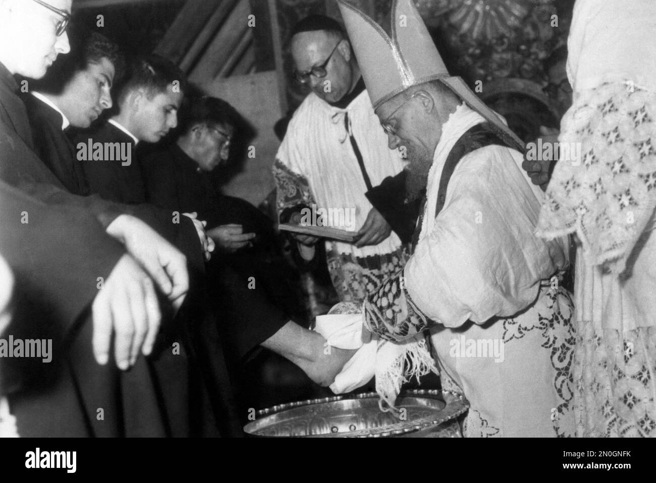 The Bishop, S.E Monsignor Fulgenzio Pasini Vescovo Latino, washes the ...