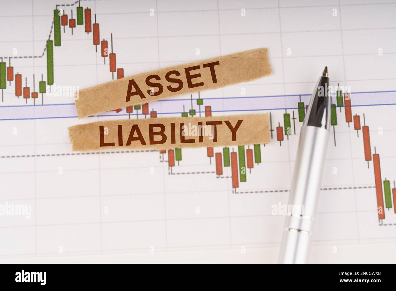 Business concept. On the chart of business quotes lies a pen and torn ...