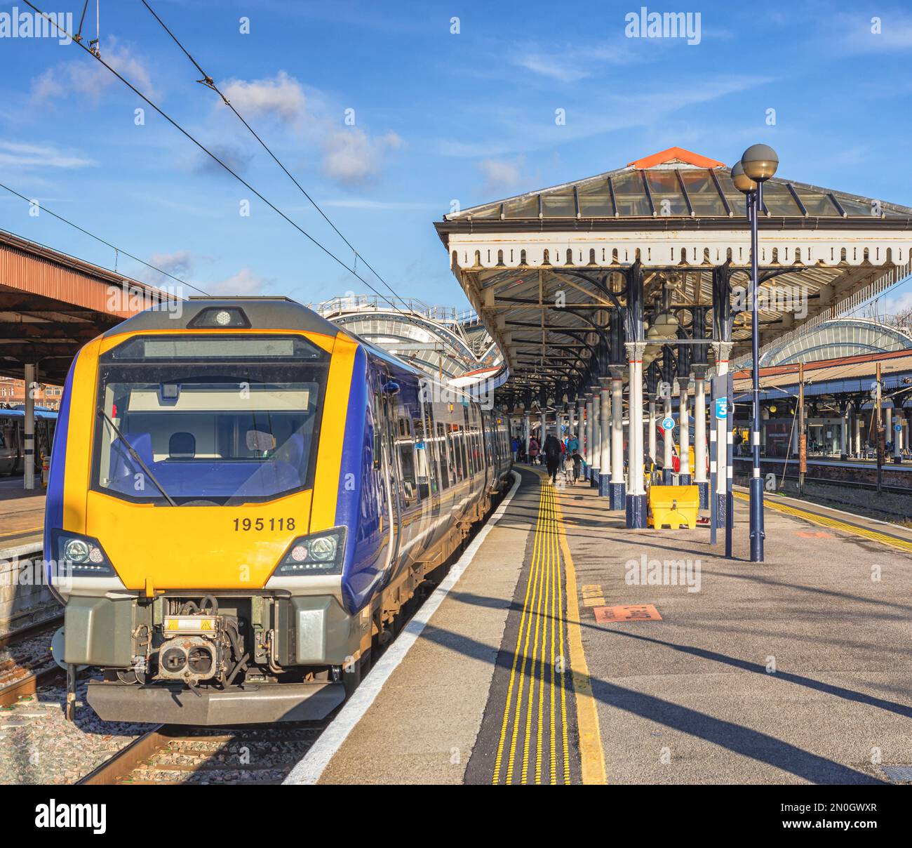A view of a railway station with rails leading towards an iron arch ...