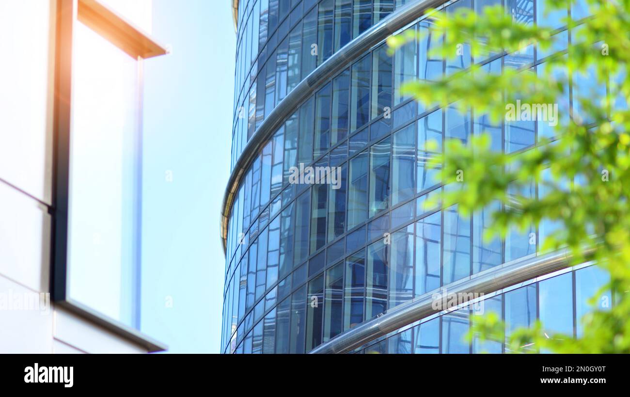 Eco architecture. Green tree and glass office building. The harmony of ...