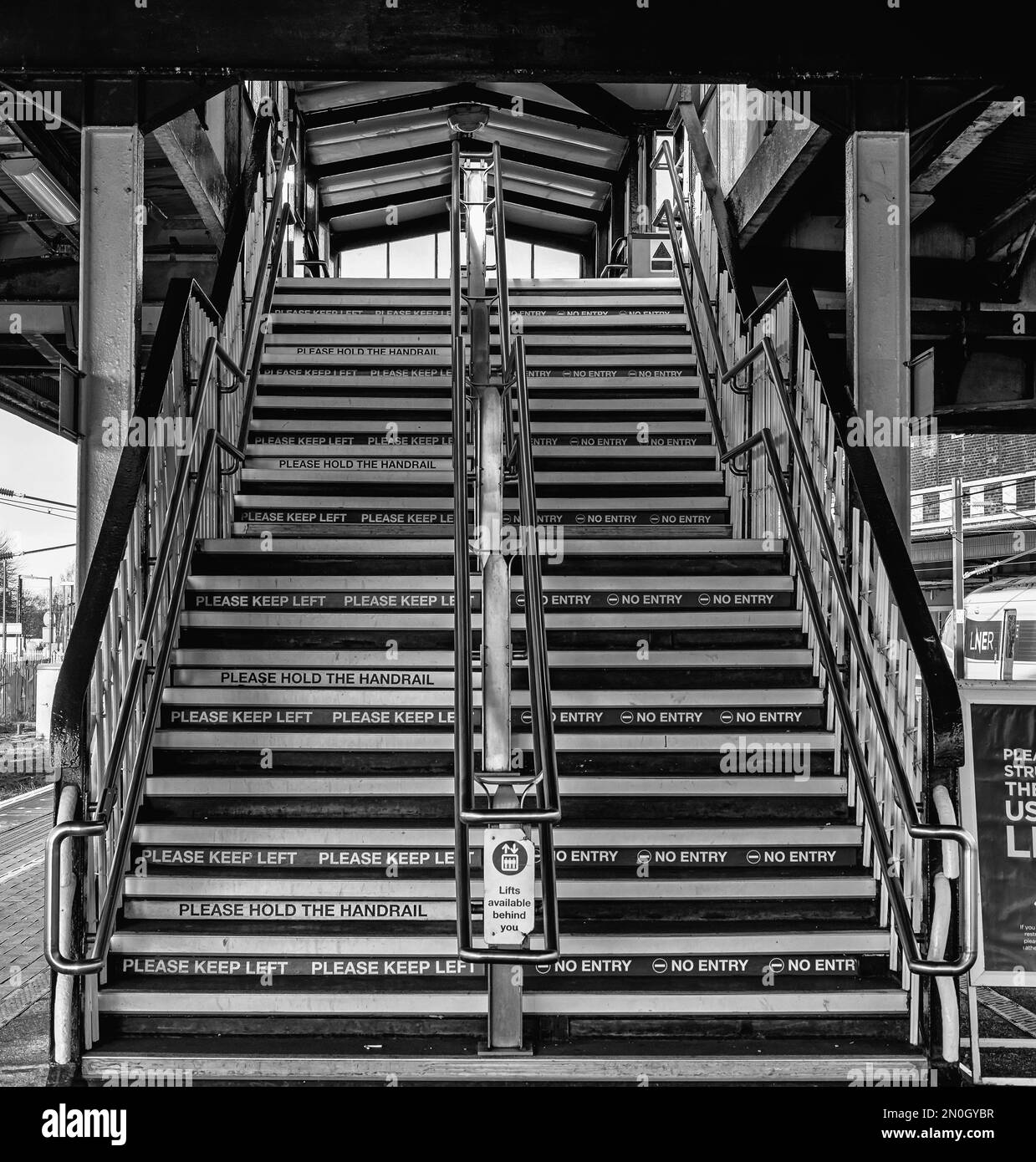 A flight of steps lead up from a railway station platform to a ...