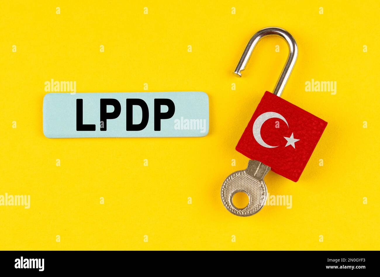 On a yellow surface, an open lock with the image of the flag of Turkey ...