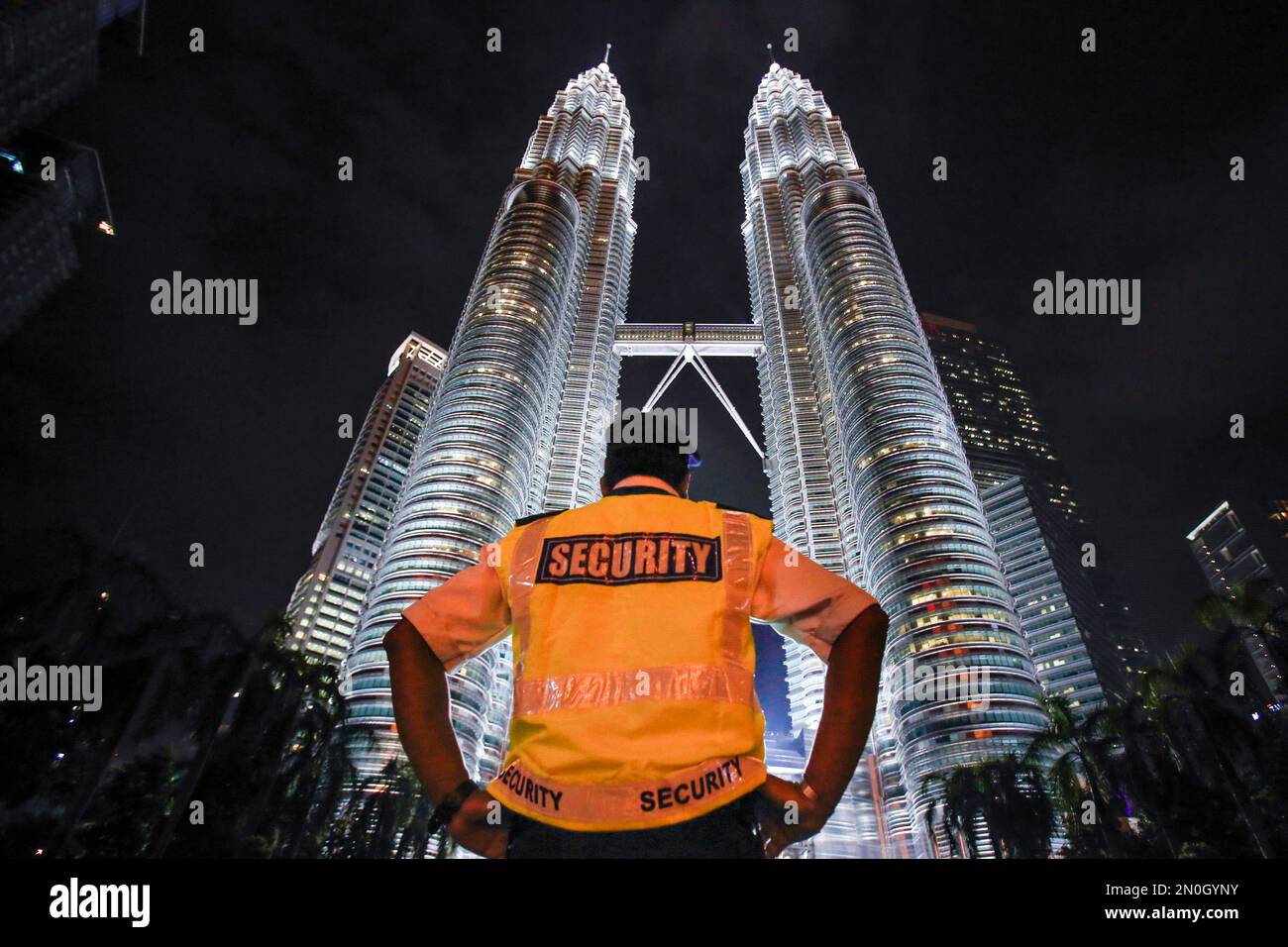 A security guard stands guard in front of Malaysia's iconic building ...