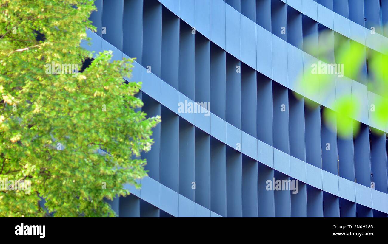 Eco architecture. Green tree and glass office building. The harmony of ...