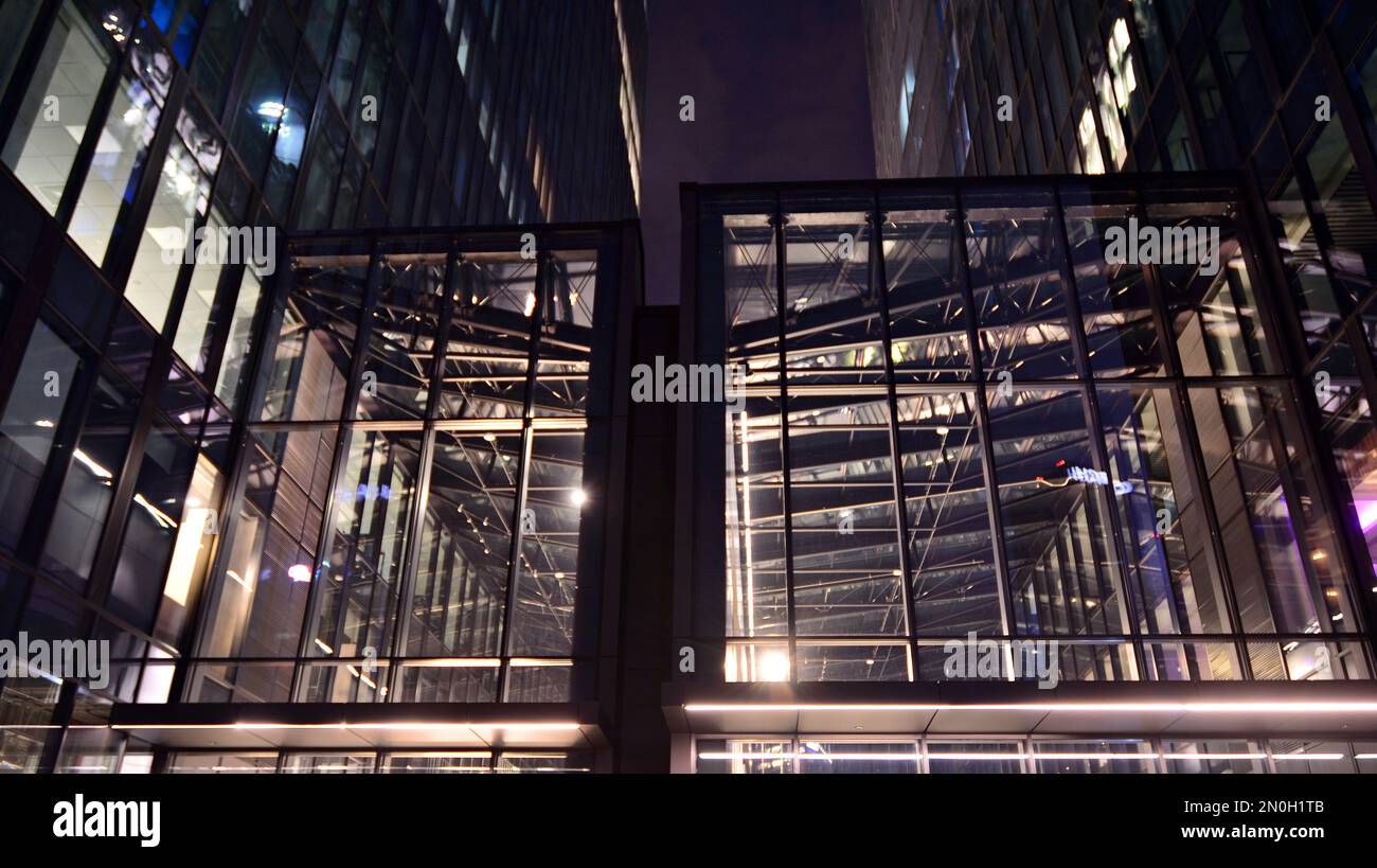Pattern of office buildings windows illuminated at night. Lighting with ...
