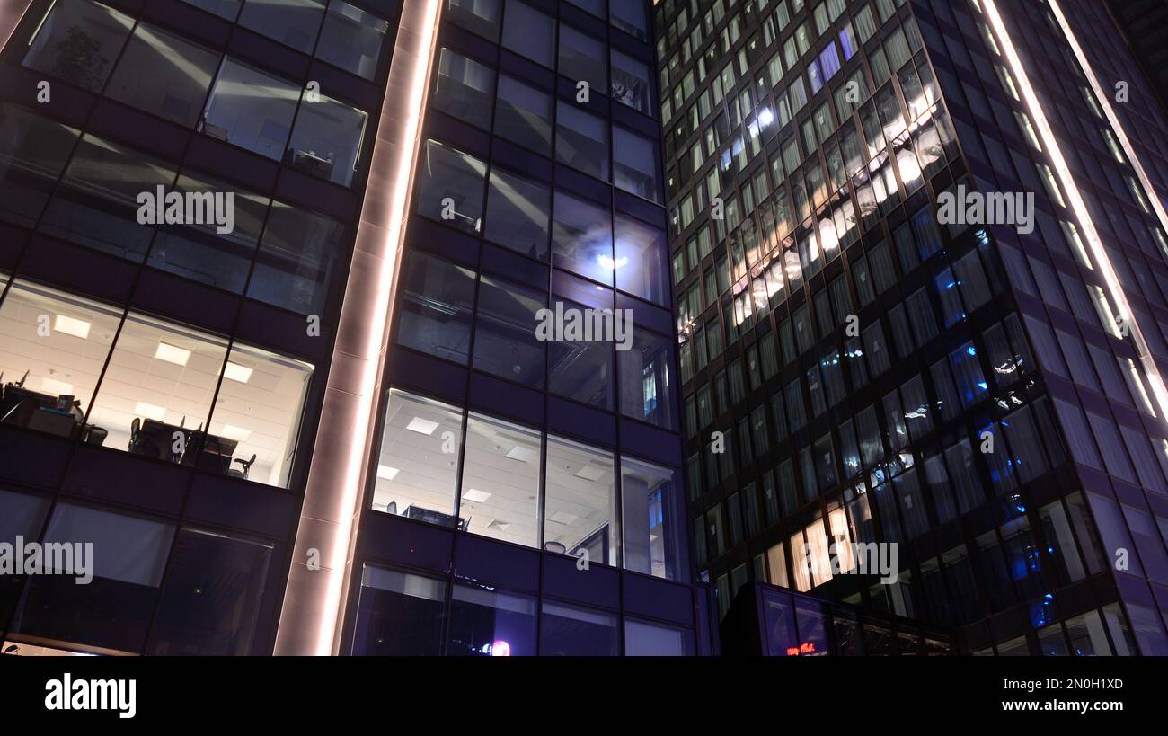 Pattern of office buildings windows illuminated at night. Lighting with ...